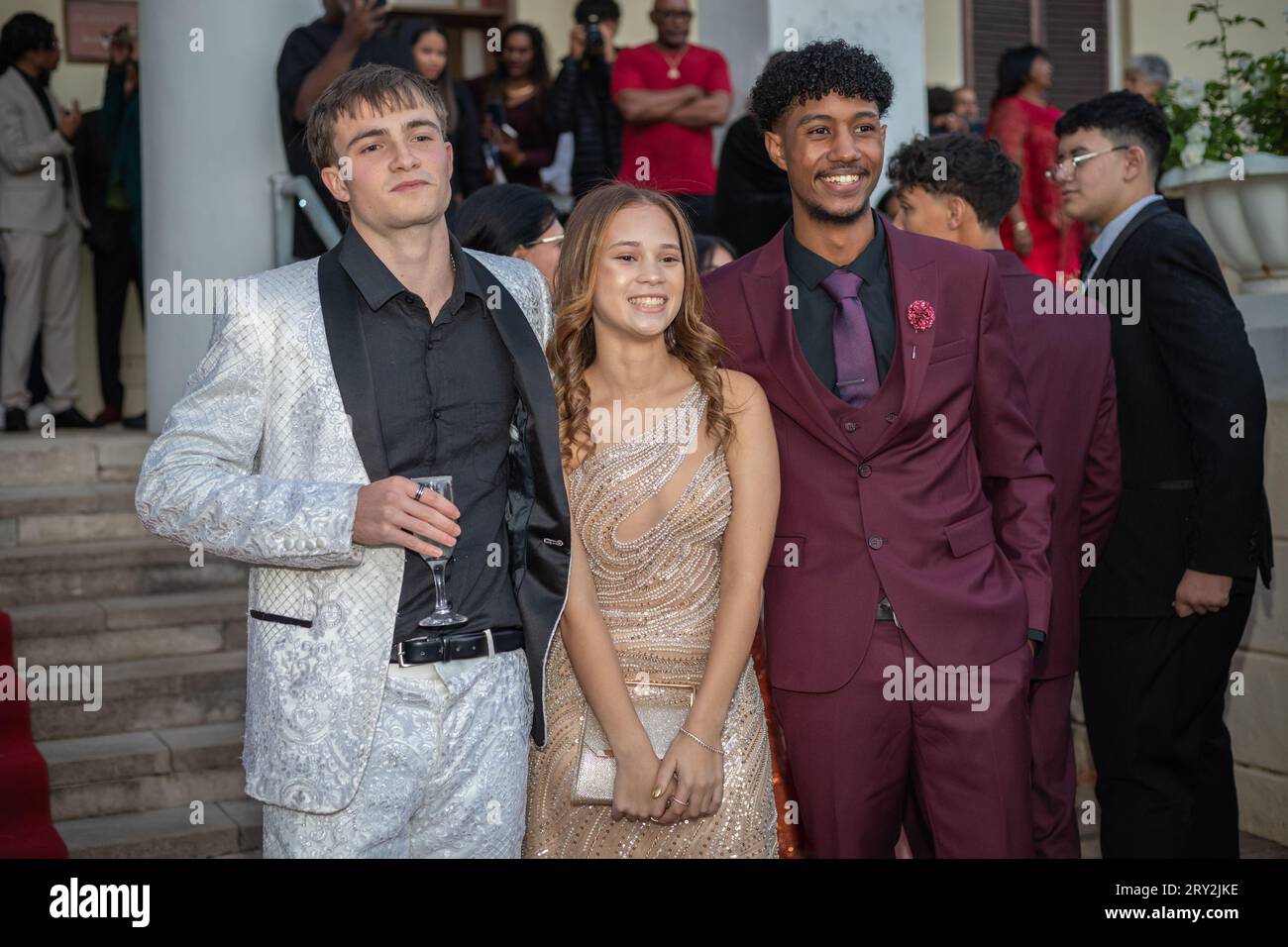 In a close-up prom photo, three multiracial friends, pose with ...