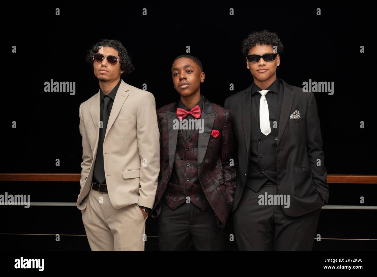 In a relaxed prom moment, three multiracial young men casually pose ...