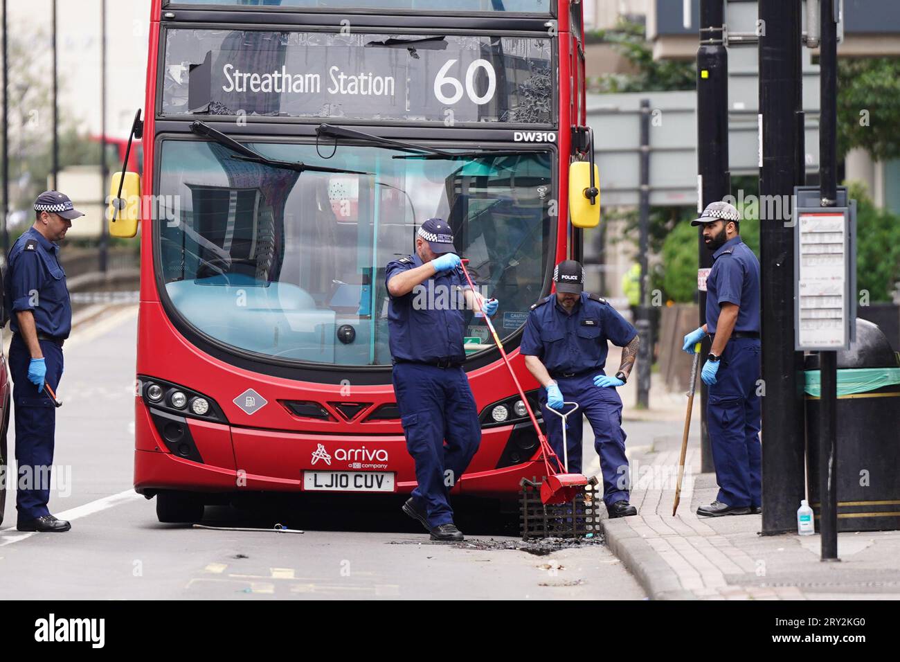 Police officers searching the scene in Croydon, south London, where 15 ...