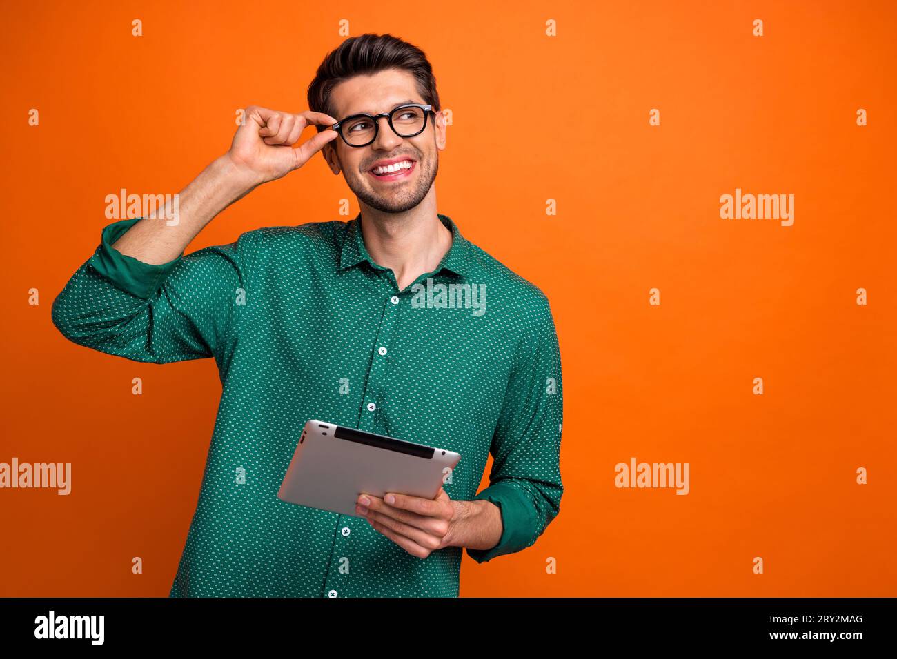 Photo of dreamy thoughtful guy wear green shirt typing modern gadget ...