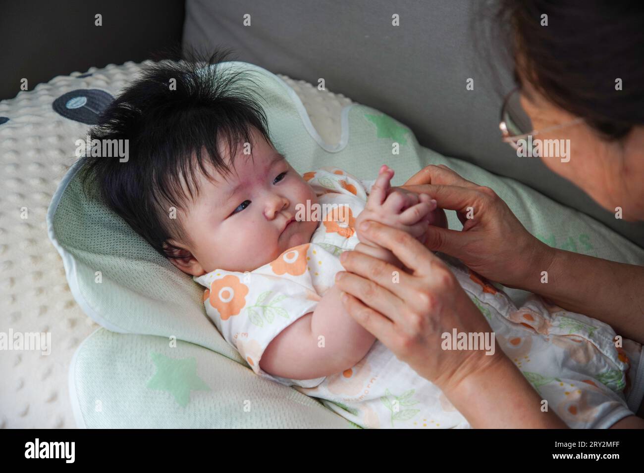 Beijing, China - May 6, 2023: A woman is coaxing a child to play on the ...