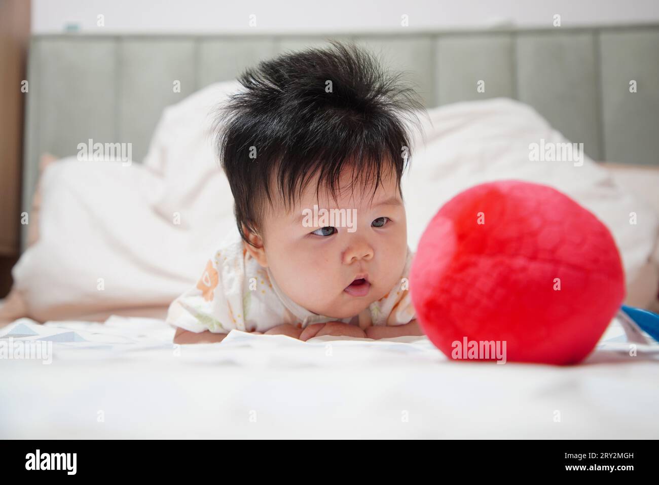 Beijing, China - May 6, 2023: A baby playing alone on the bed Stock ...