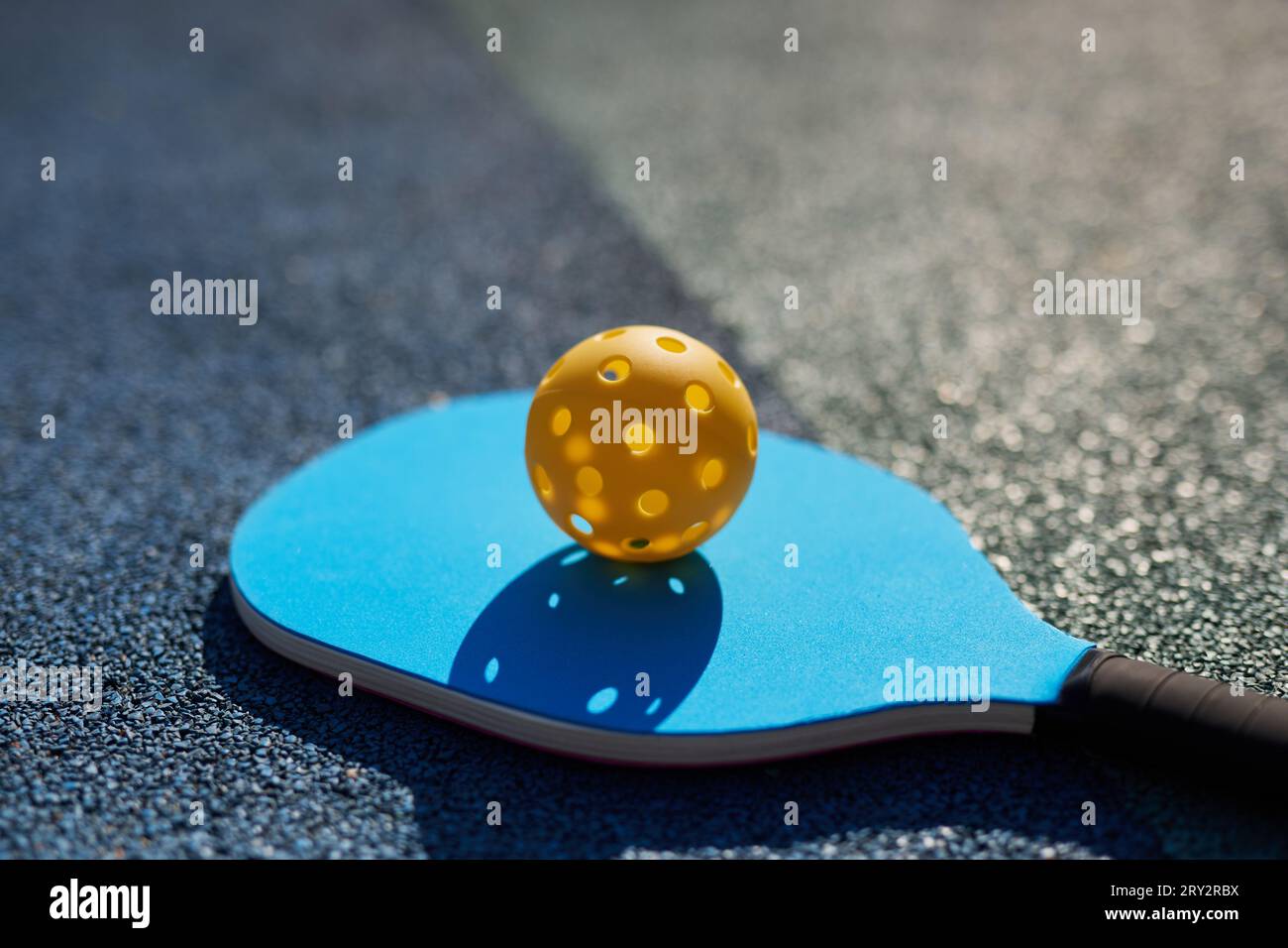 Pickle ball on a racket Stock Photo - Alamy