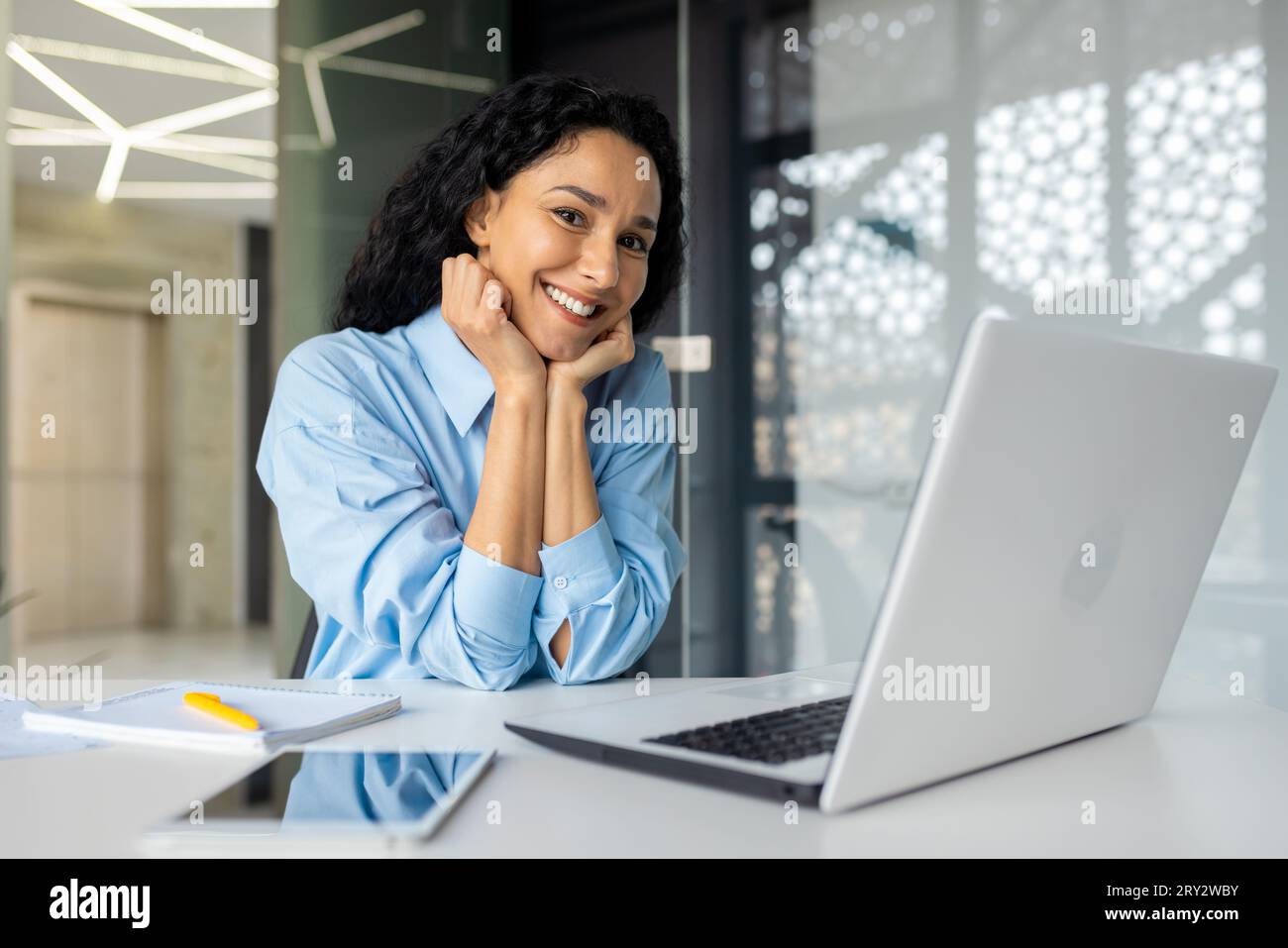 Portrait of young beautiful business woman inside office at workplace ...