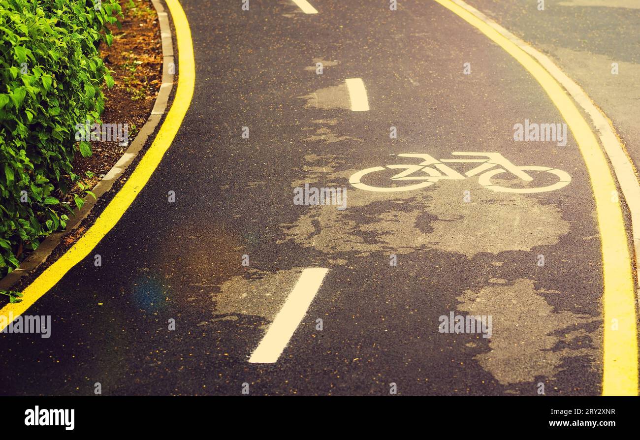 Bike Lane. Yellow and white marking on a bicycle path Stock Photo - Alamy