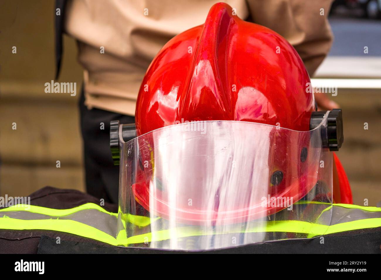 Firefighter uniform with red helmet. image of a red helmet of a fireman ...
