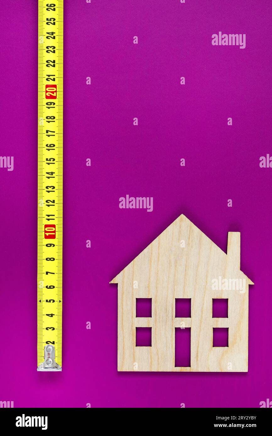 The image of the house on the background. Measurement of the size, tape ...