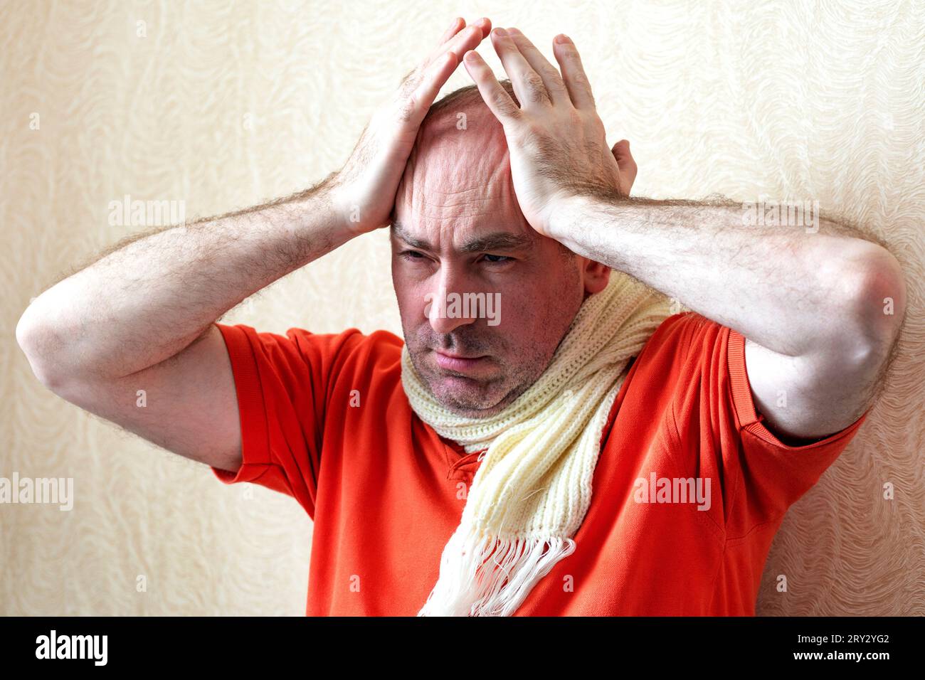 A sick man holds his hand over his head. The patient has a headache ...