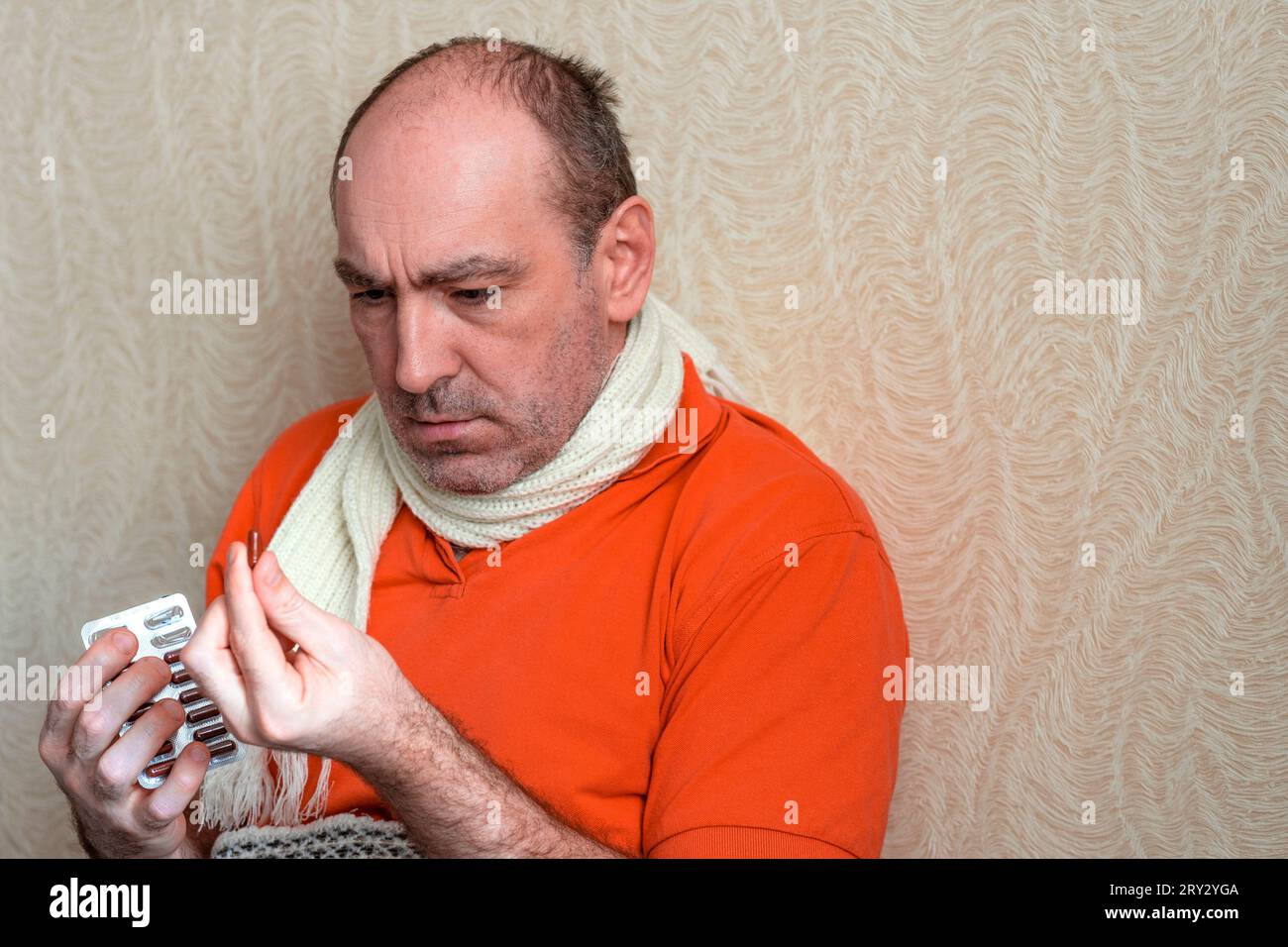A sick man holds his hand over his head. The medication, treatment ...