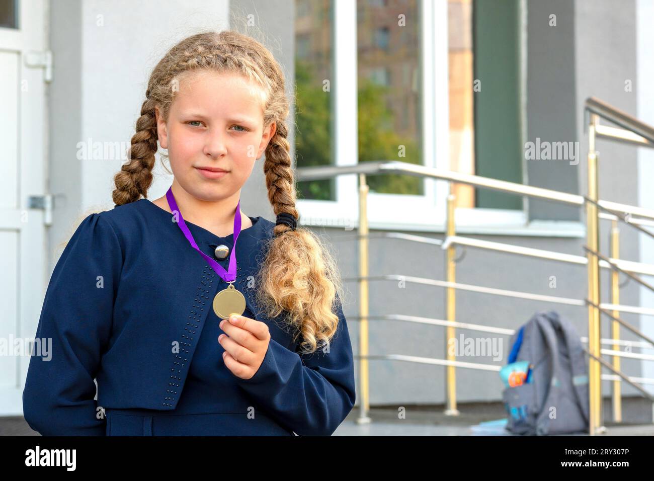 girl in a uniform. reward schoolgirl, successful student. girl with a ...