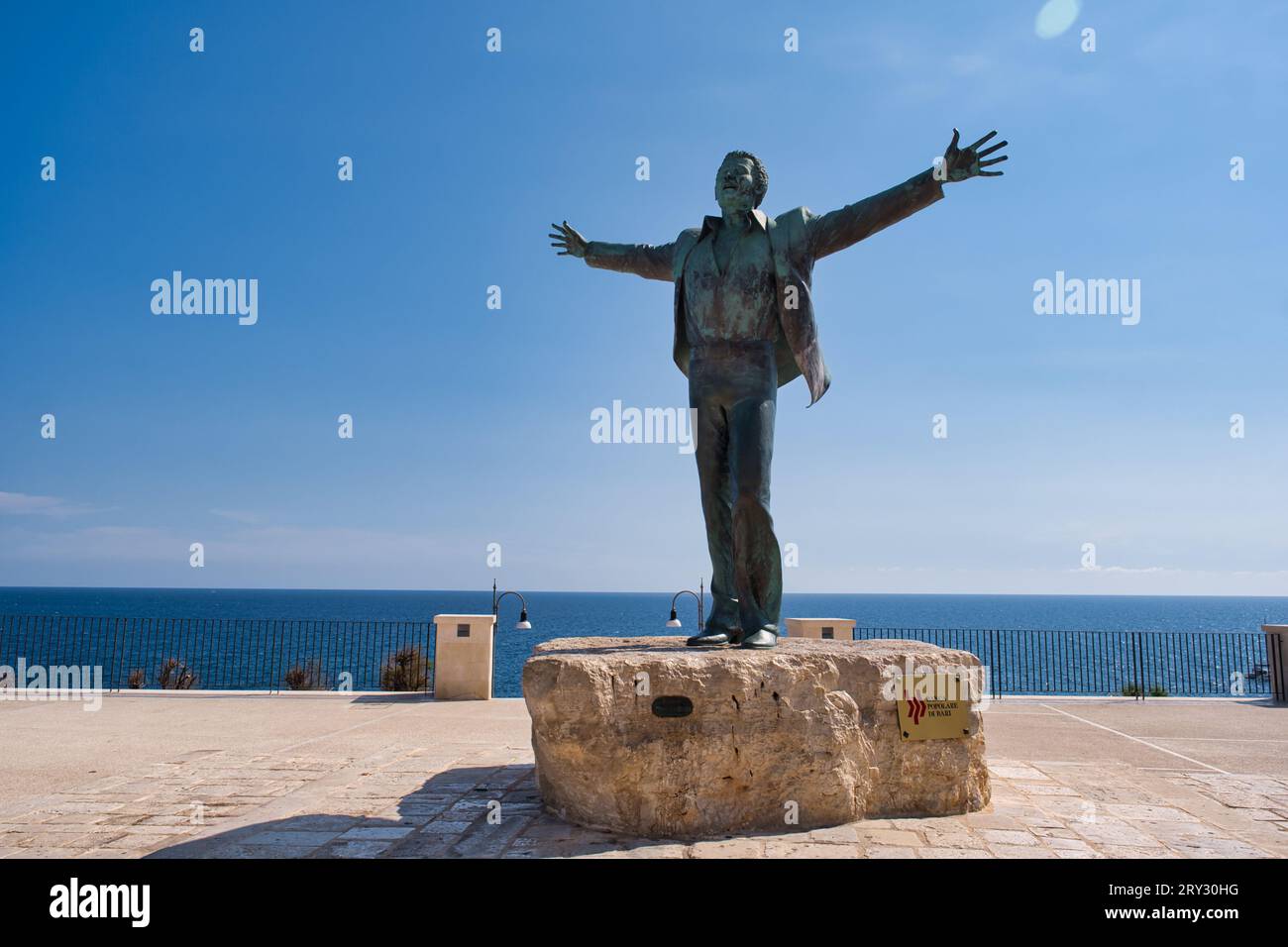 View of the Domenico Modugno bronze statue in Polignano a mare Stock ...