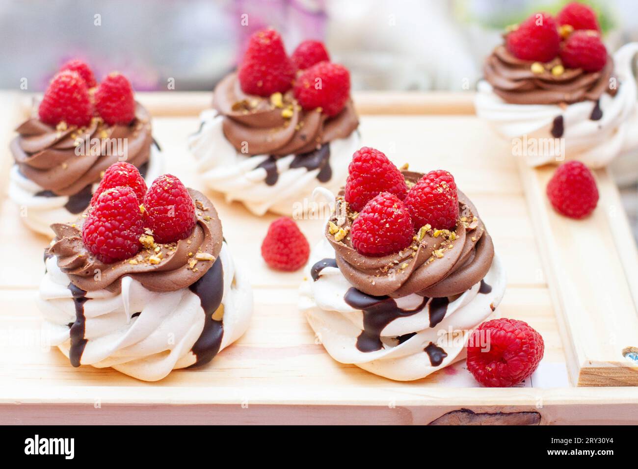 Mini cakes with whipped cream, chocolate, meringue and fresh ...