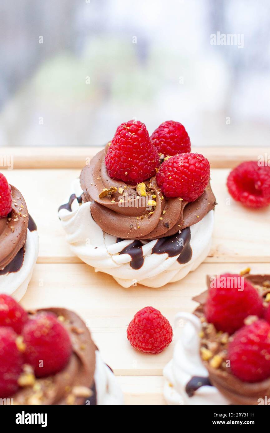 Mini cakes with whipped cream, chocolate, meringue and fresh ...