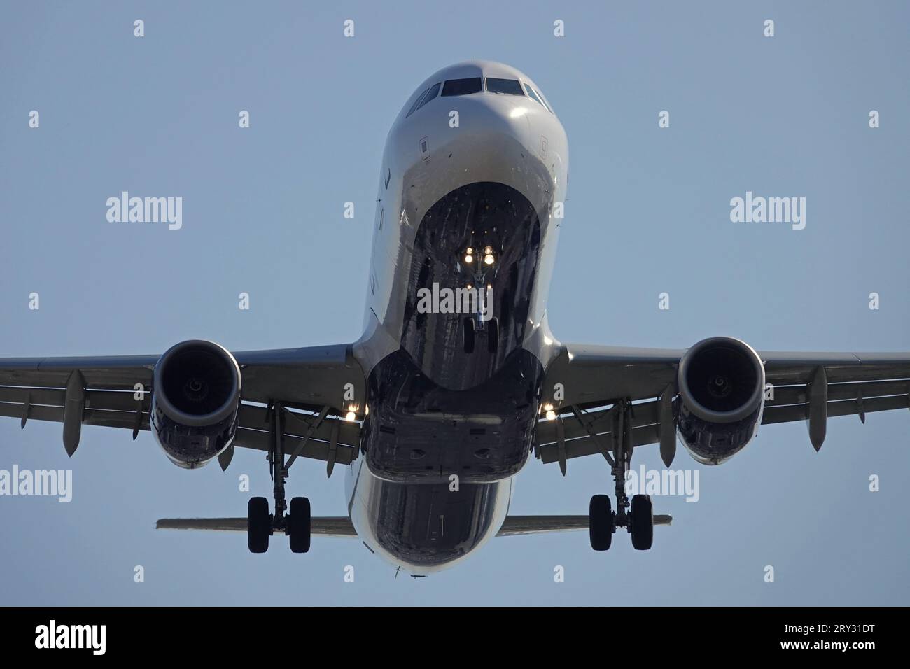 A large jet airliner, with the landing gear down, is shown during final ...