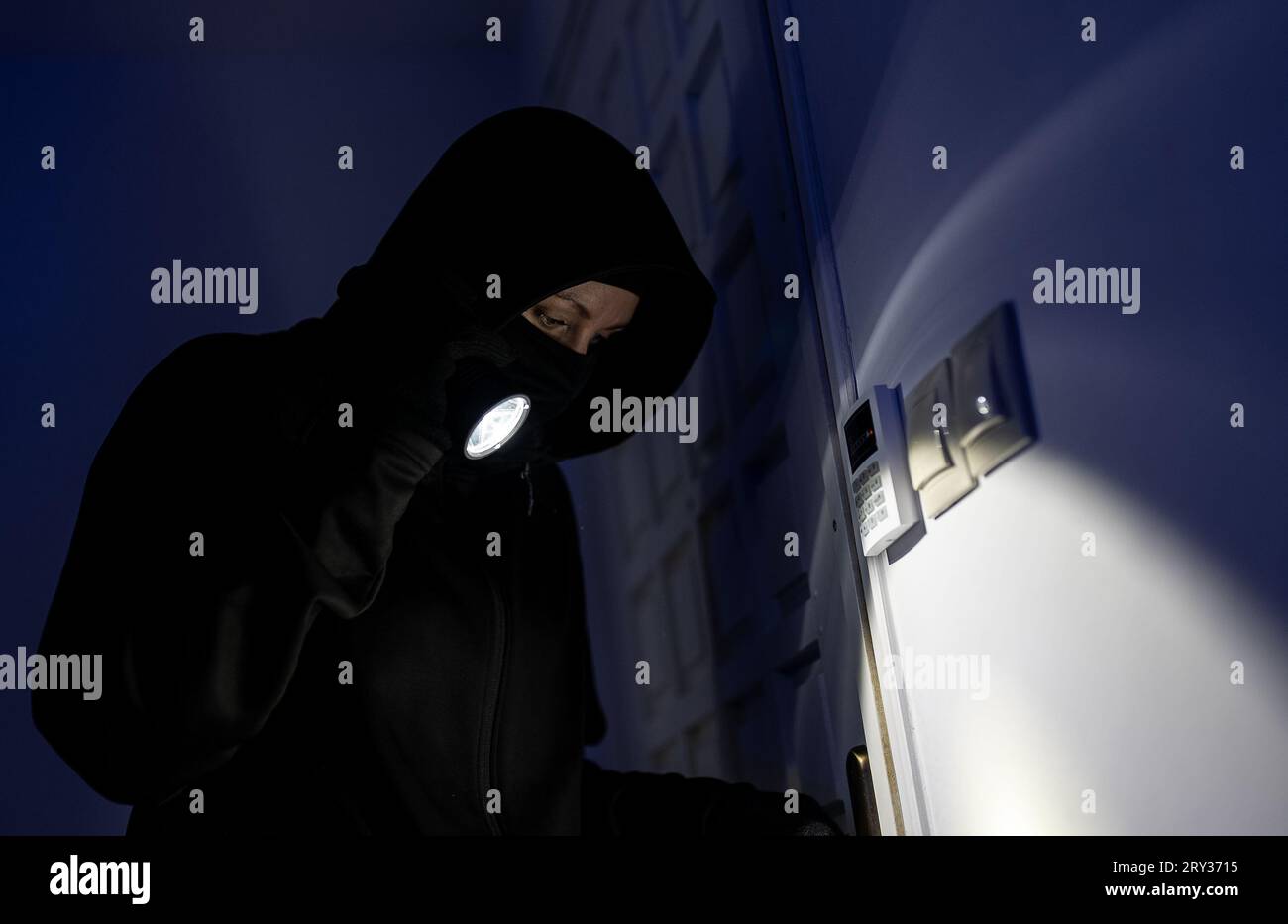 Female thief breaks into the apartment through the front door Stock ...