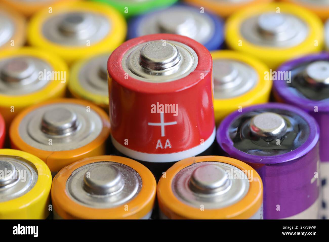 many round batteries and one red battery Stock Photo - Alamy