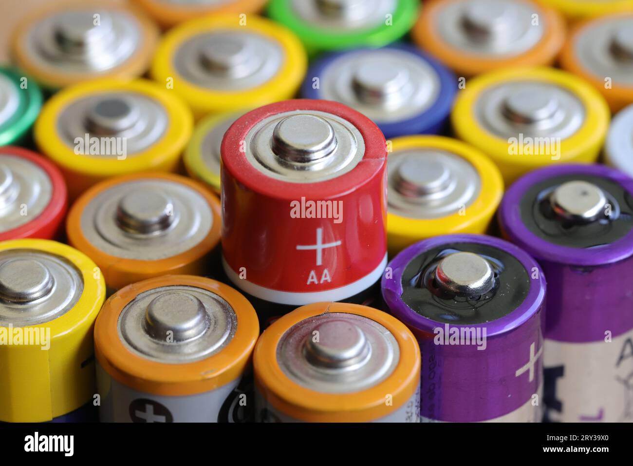 many round batteries and one red battery Stock Photo - Alamy