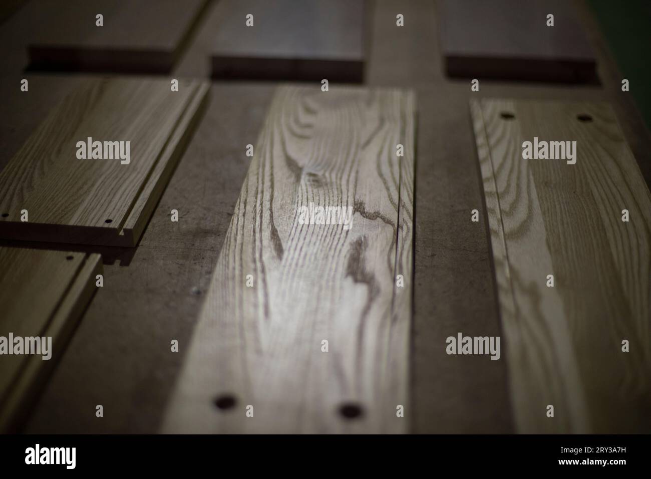 Board in carpentry workshop. Details of furniture manufacturing. Wood ...