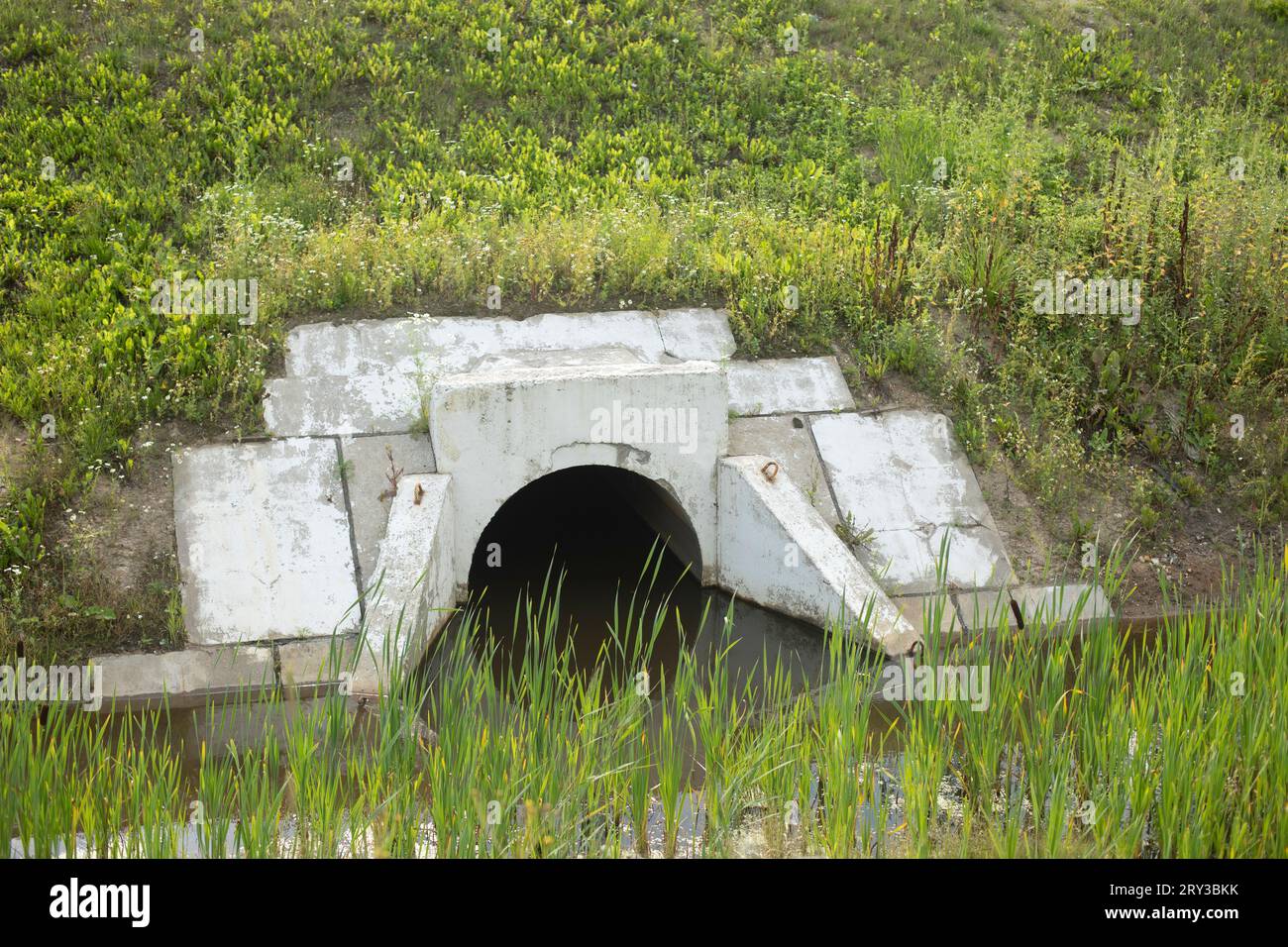 Collector under the highway. Draining water by the road. Water drainage ...
