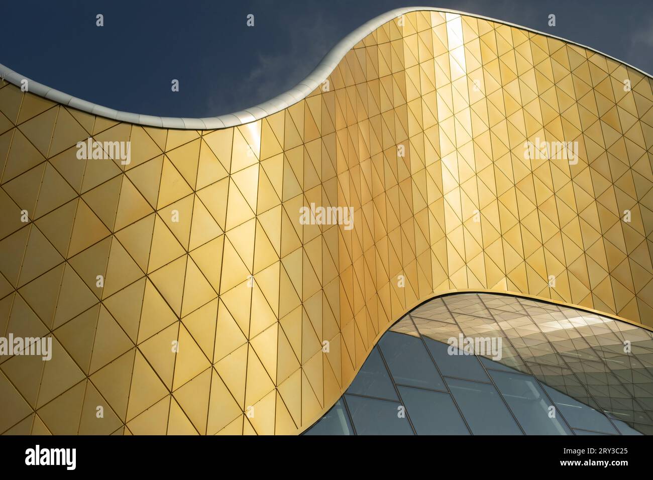 Modern building made of glass and metal. Golden color in architecture ...