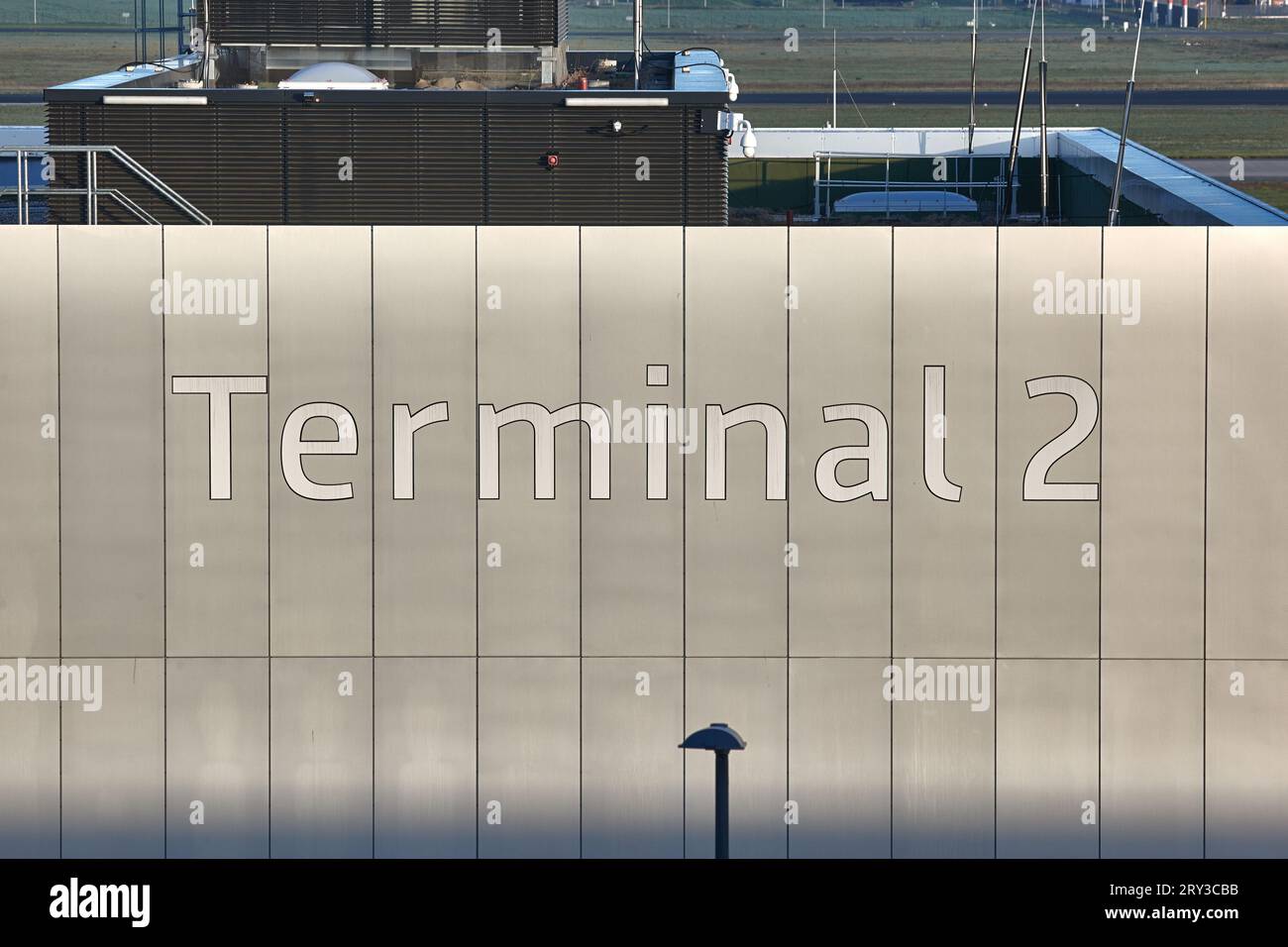 Terminal 2 sign on airport terminal wall Stock Photo - Alamy