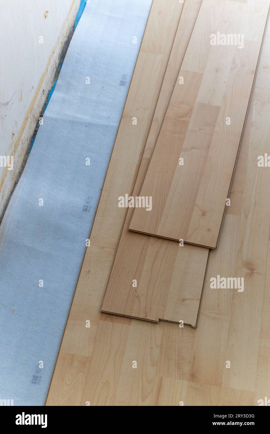 A vertical portrait of a stacked pile of wood imitation laminate ...