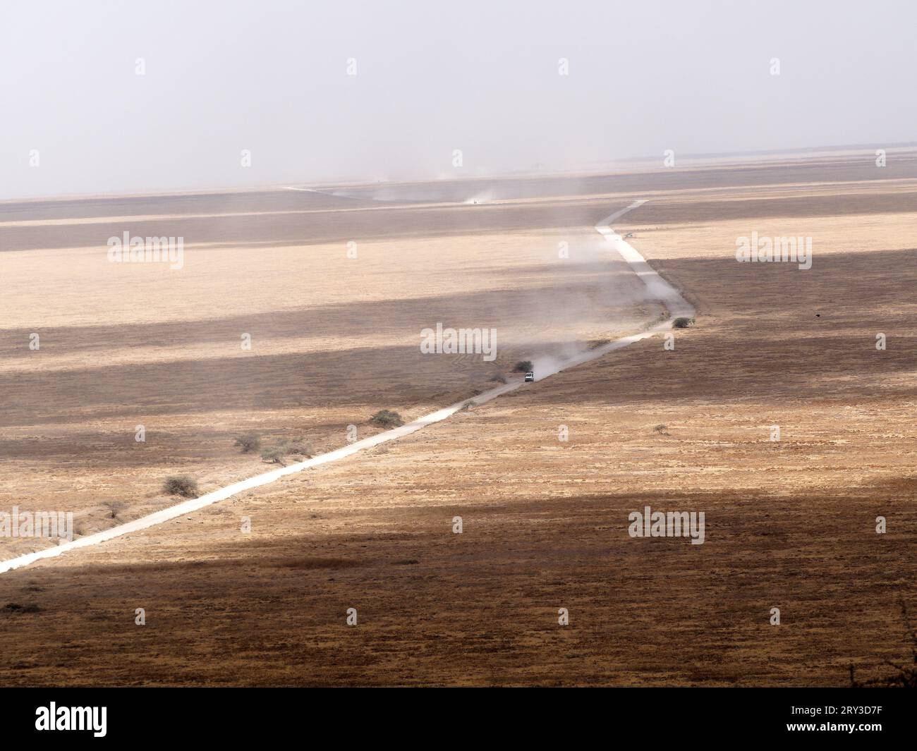 View looking down on a road crossing the dry arid plains of the ...