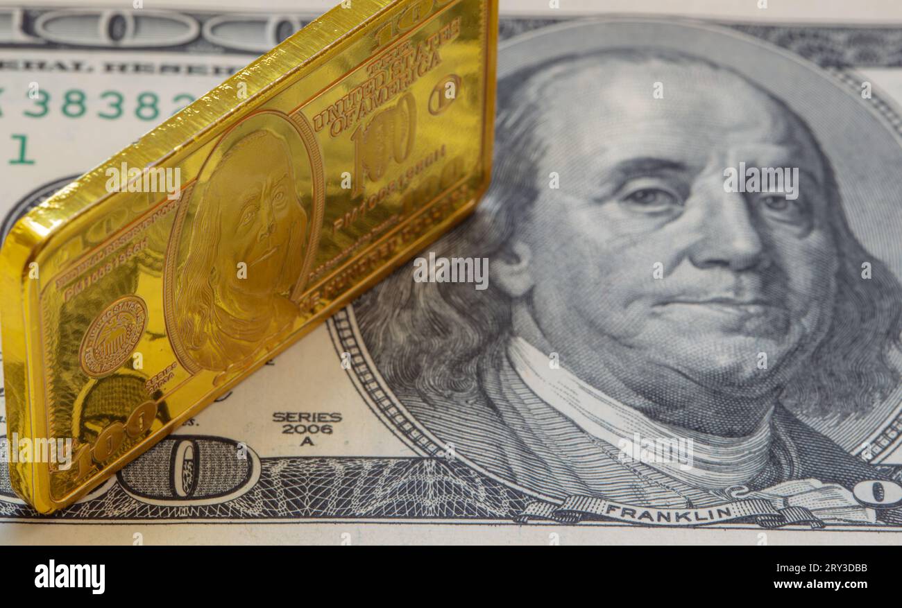 US 100 dollar golden bar die cut stamp on US 100 dollar banknote ...
