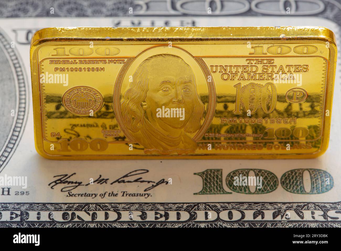 US 100 dollar golden bar die cut stamp on US 100 dollar banknote ...