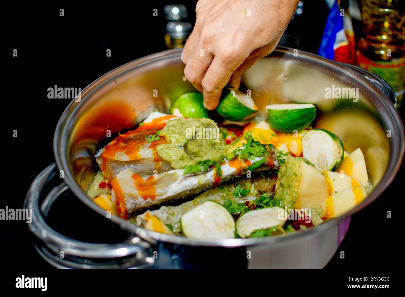 Fish being cooked with vegetables and seasonings. Healthy food. Omega 3 ...