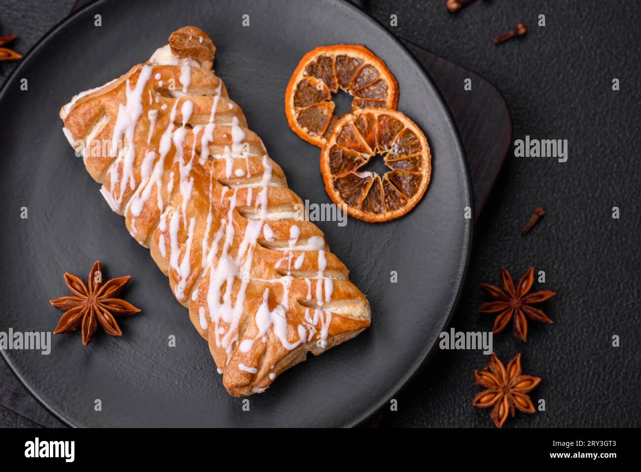 Delicious crispy braided bun with raisins inside and white icing ...