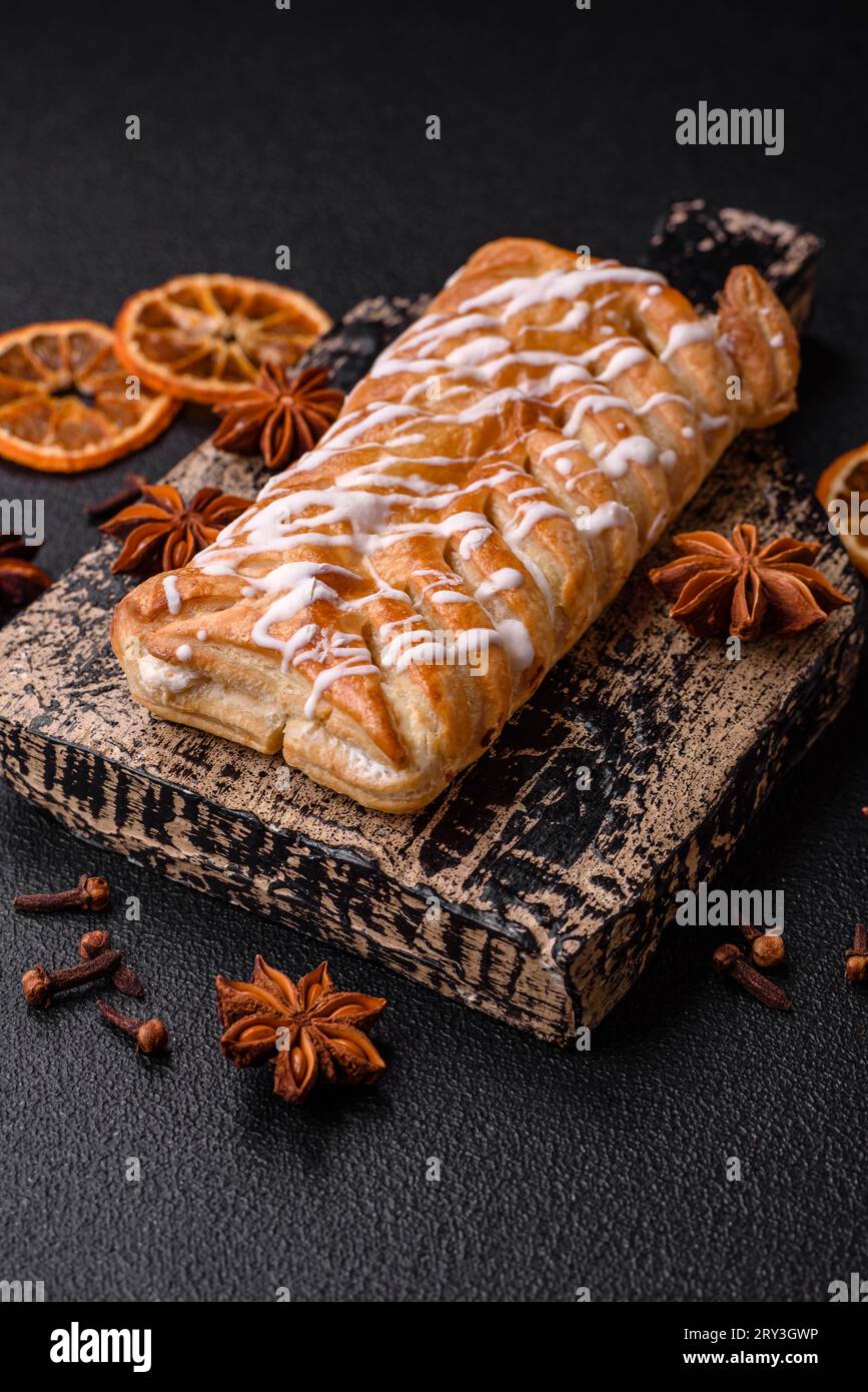 Delicious crispy braided bun with raisins inside and white icing ...