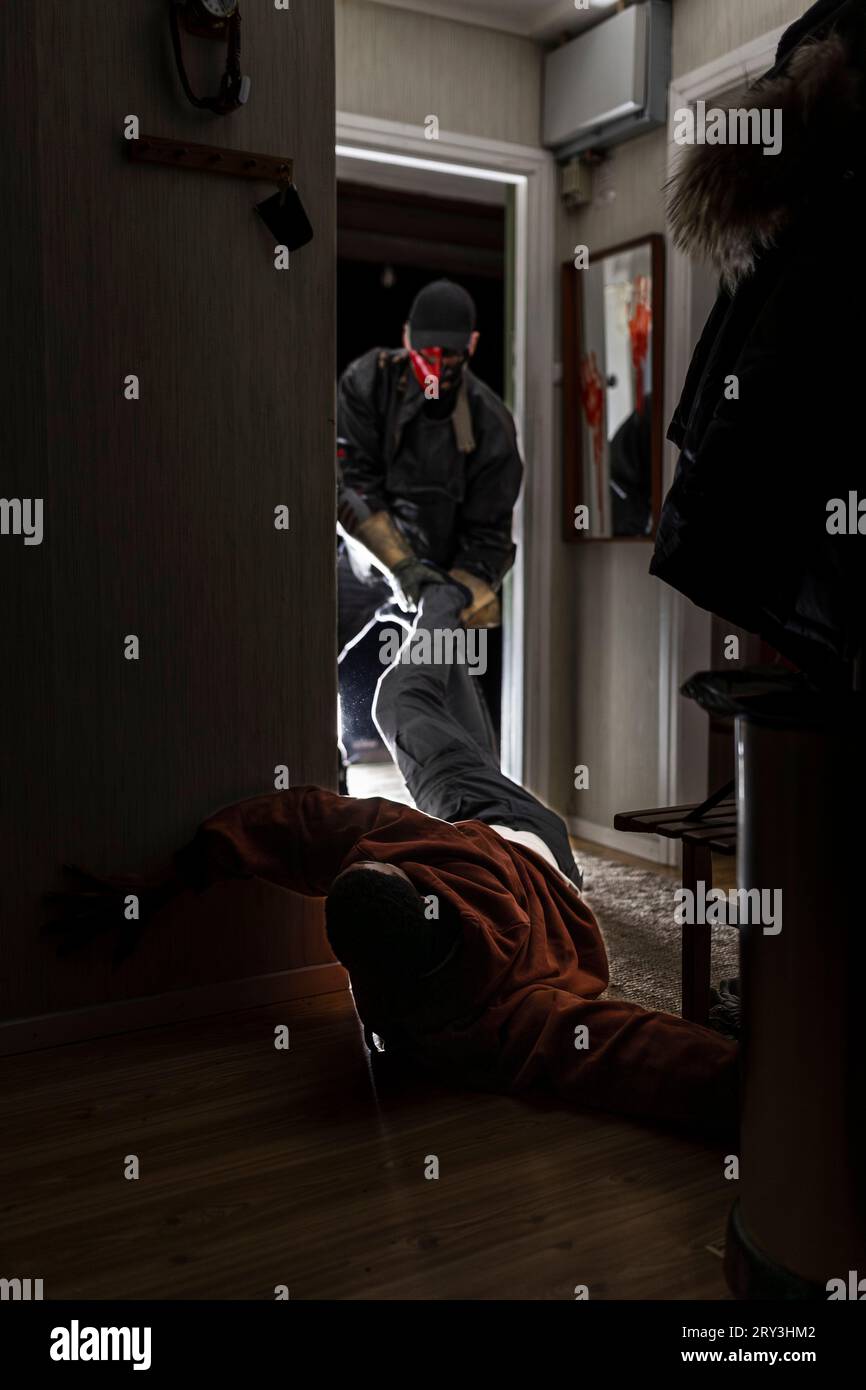 Demon wearing mask pulling man in cabin Stock Photo - Alamy