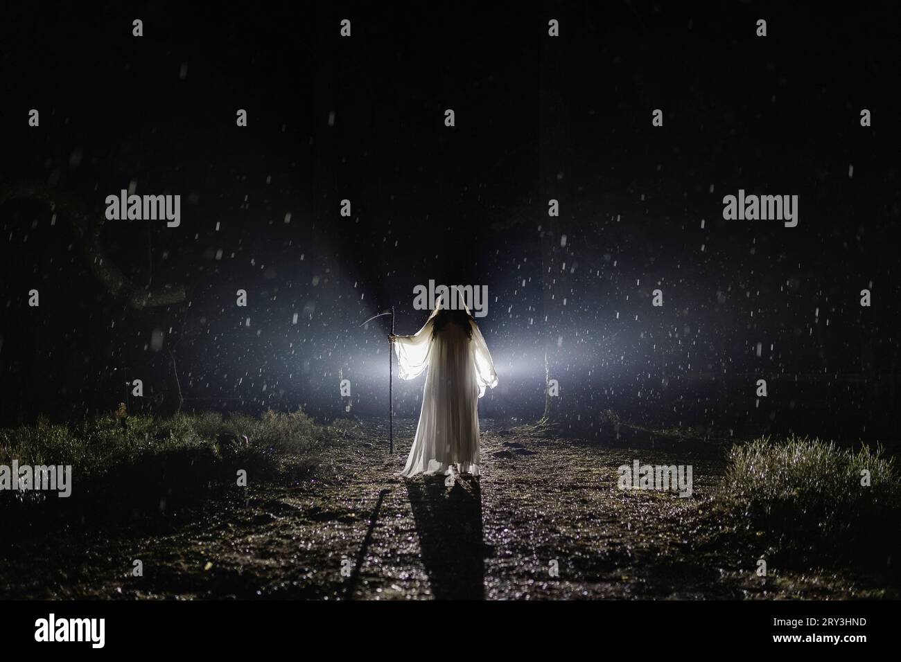 Ghost with scythe standing in forest at night during rainy season Stock ...