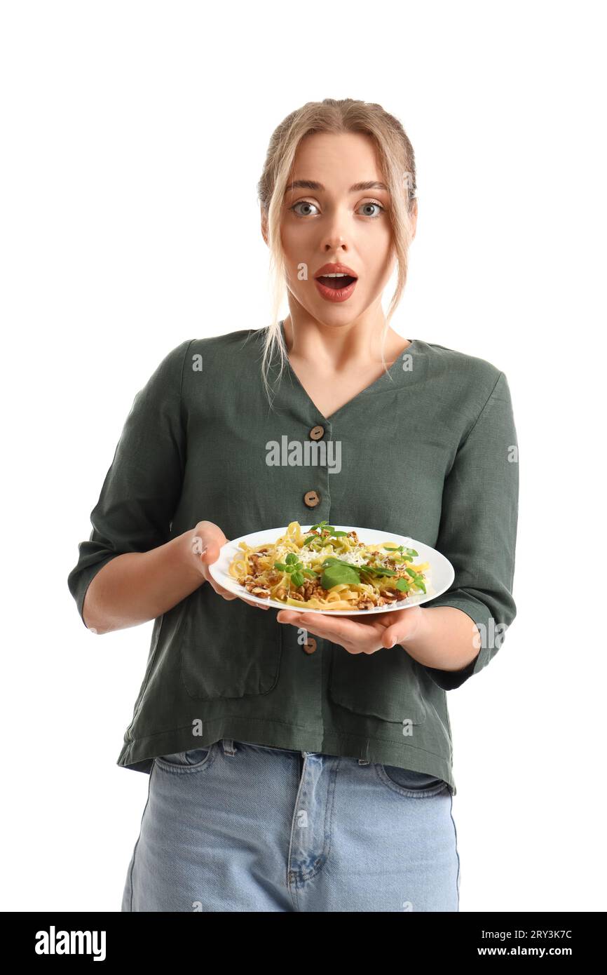 Shocked young woman with tasty pasta on white background Stock Photo ...