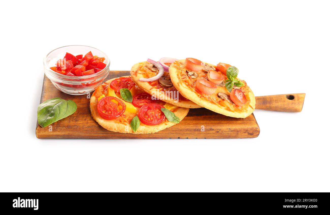 Board with different tasty mini pizzas and ingredients on white ...