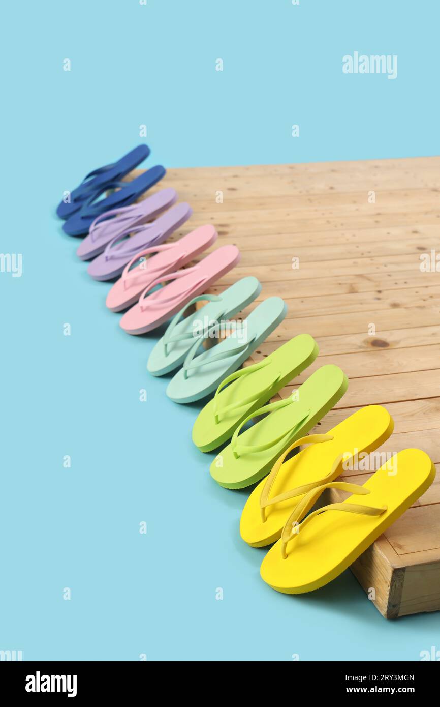 Many different flip-flops on blue background Stock Photo - Alamy