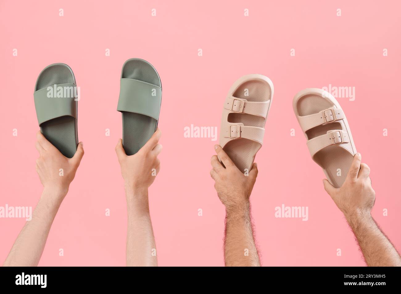 Hands with flip-flops on pink background Stock Photo - Alamy