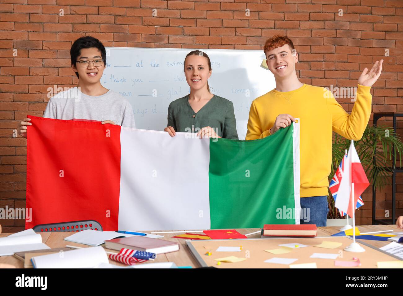 Young students with Italian flag at language school Stock Photo - Alamy