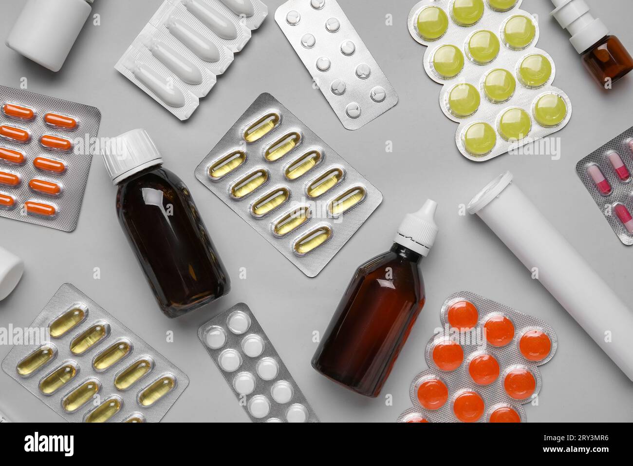 Different pills and bottles of medicines on grey background Stock Photo ...
