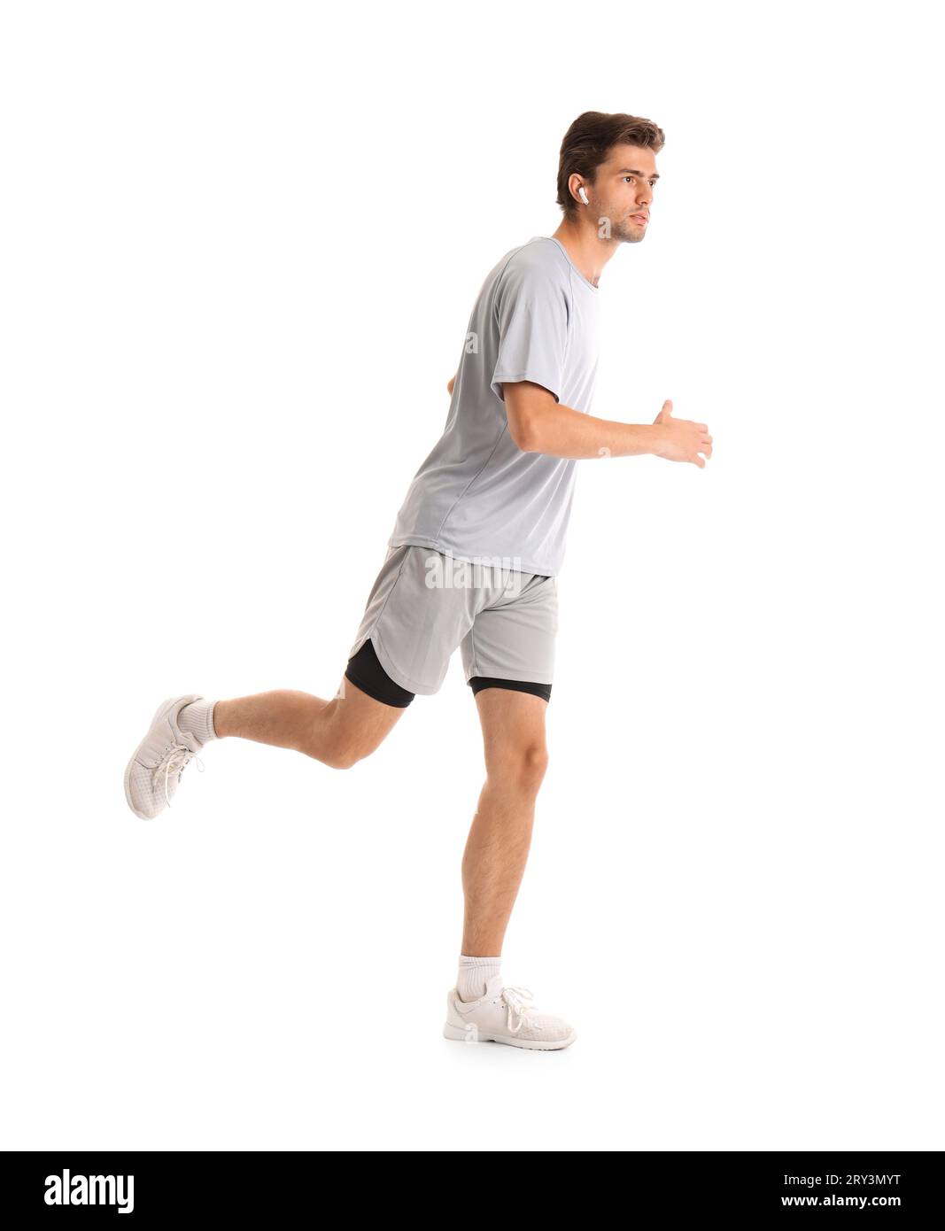 Sporty young man running on white background Stock Photo - Alamy