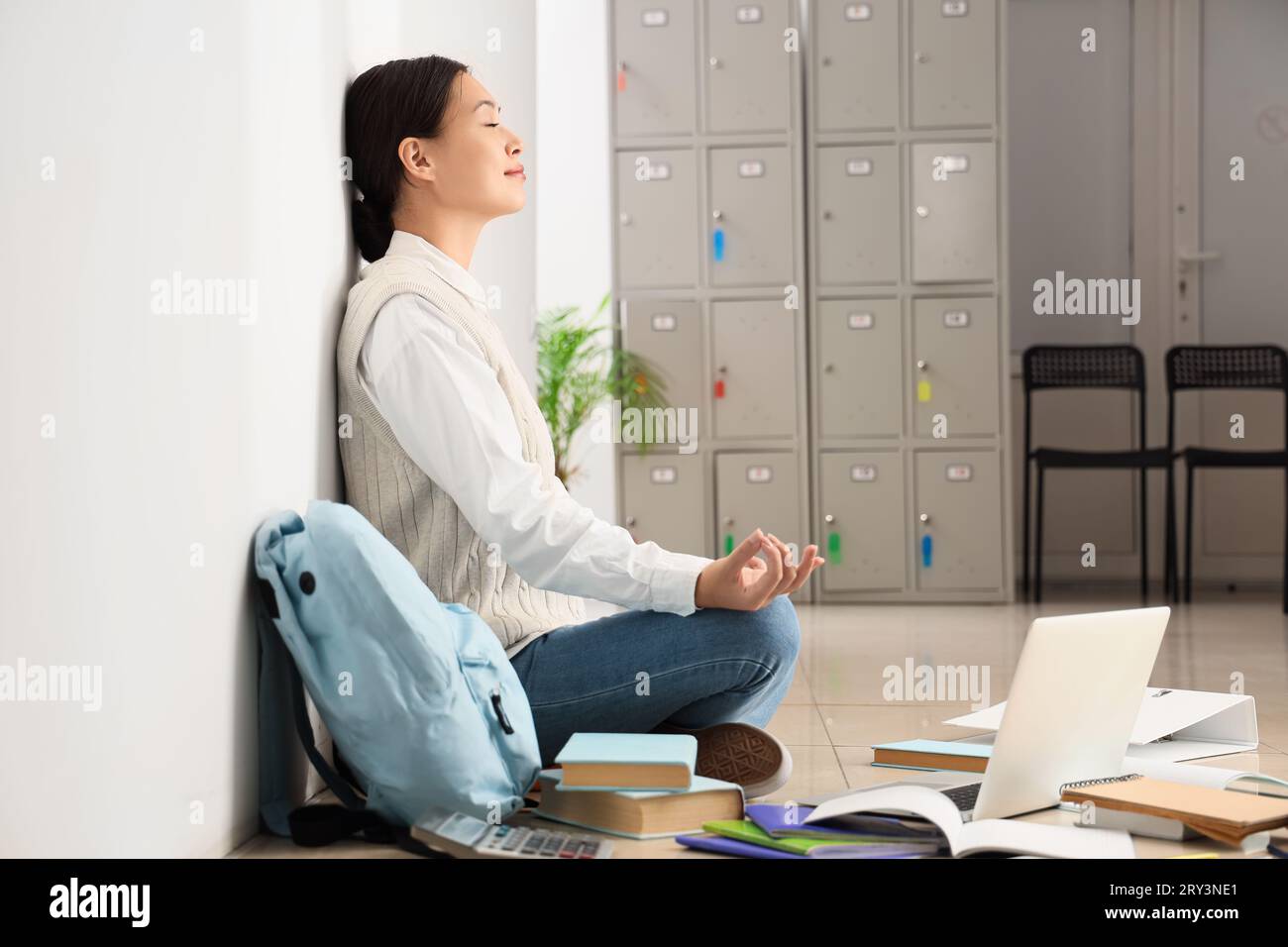 Female Asian student meditating at university hall Stock Photo - Alamy