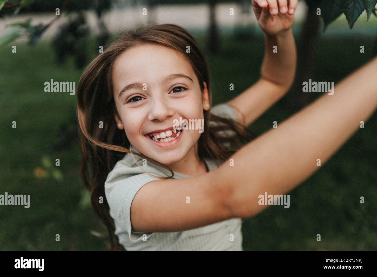 Portrait of cheerful girl dancing at park Stock Photo - Alamy