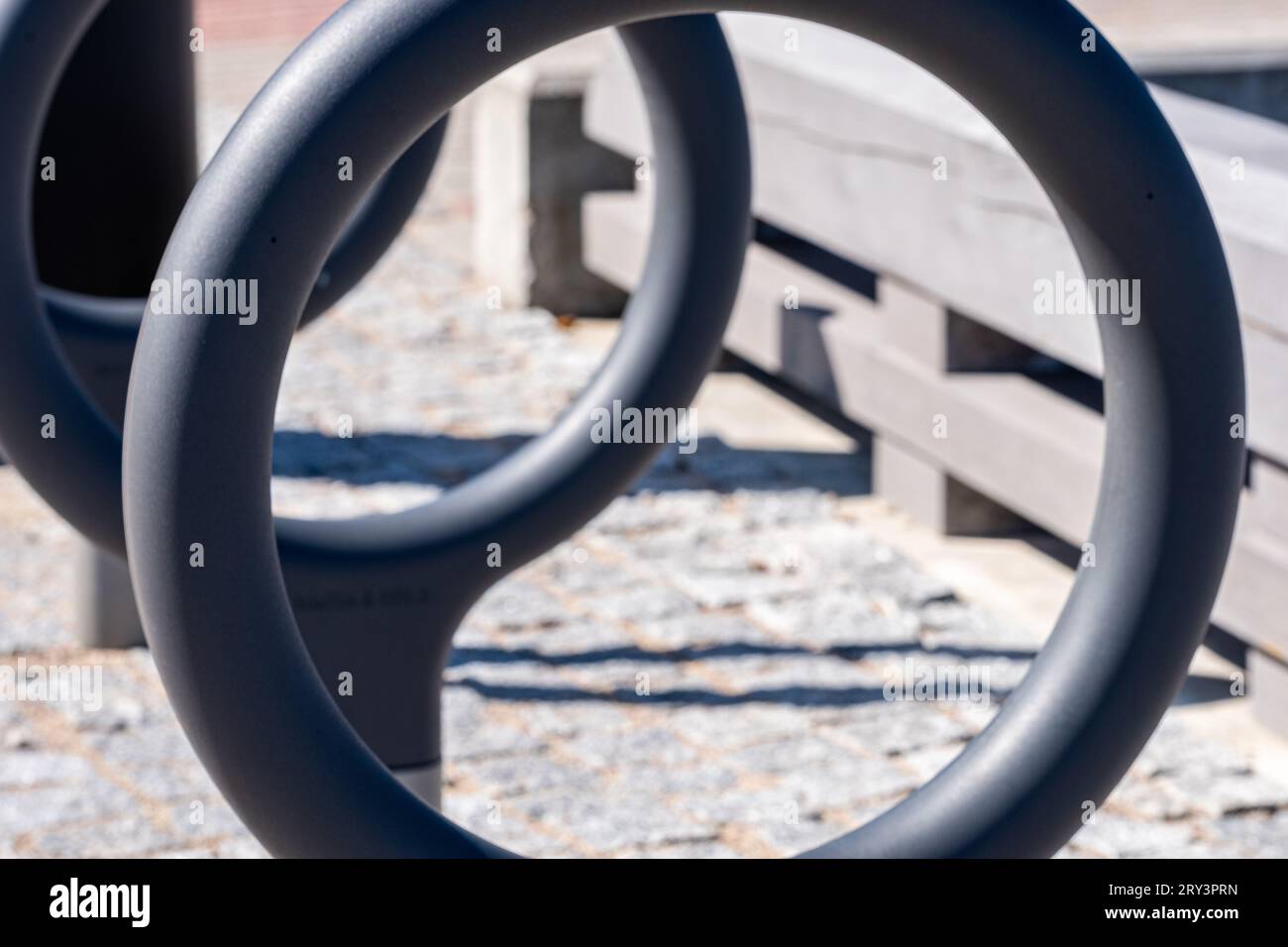 Modern black metal wheeled parking structure in a sunny day. Metal ...
