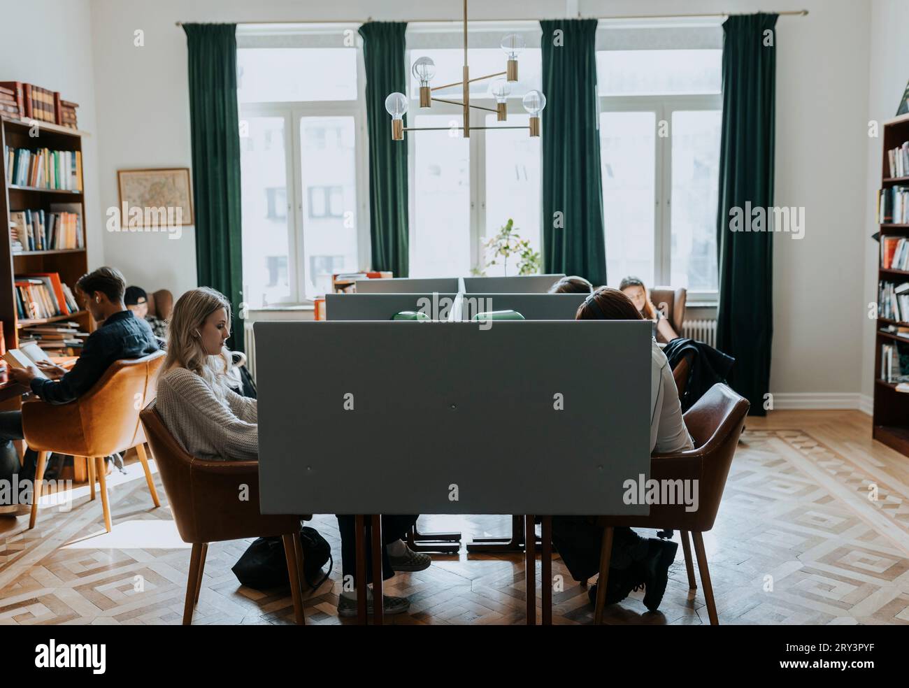 Students studying in library at school Stock Photo - Alamy