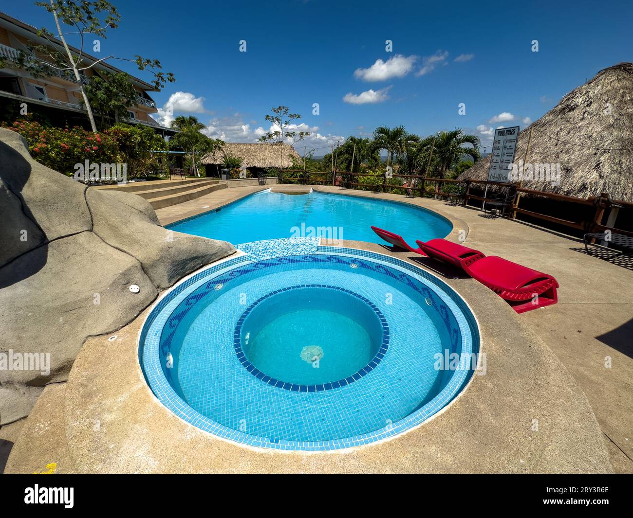 The blue-tiled hot tub and swimming pool at the Cahal Pech Village ...
