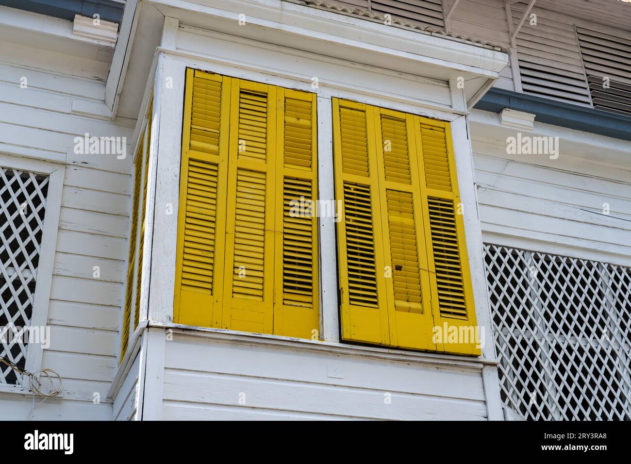 Painted shutters on an old British colonial house in Belize City ...