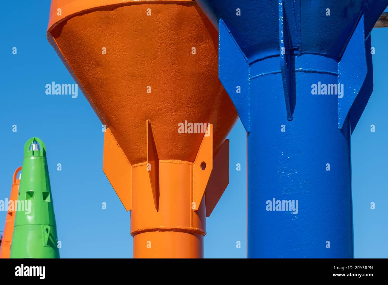 Robust, huge metal structures, painted in orange, blue and green. Clear ...