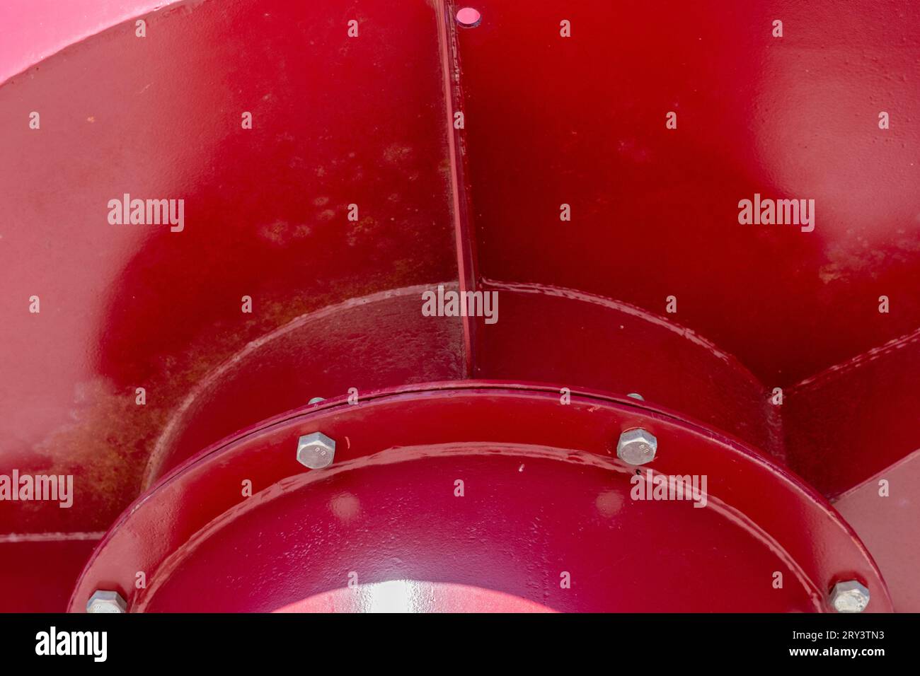 Bright red metal parts bolted together. Copy space. Background for ...