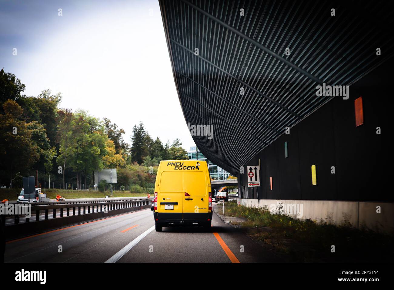 Yellow van on the road in Bern, Switzerland. Image captured on back ...